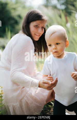 Adorable baby boy learning to crawl and playing with colorful toy in ...