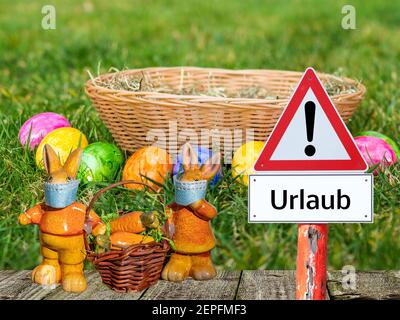 Corona warning sign with Easter bunny and basket Stock Photo - Alamy