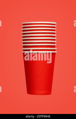 Row of red paper cup on green background with copy space. creative ...