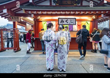 Omikuji (fortune-telling paper strip) tied to a rope at a Japanese temple in Nikko, Japan Stock ...