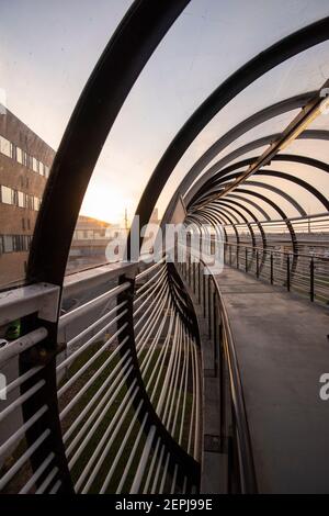 Morning light on the Sir Peter Mansfield tram bridge at the Queens ...