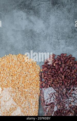 Different kinds of beans packed on a gray background Stock Photo - Alamy