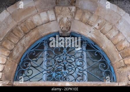 A stone lintel set in elaborately semi-circular upper window, with a ...