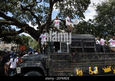 Kids dance atop a car during a vibrant second line parade in the Treme ...