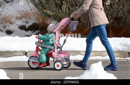 A mother pushes her baby in a stroller wearing gas masks Stock Photo ...