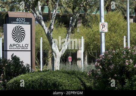 A logo sign outside of the headquarters of the Apollo Education Group ...