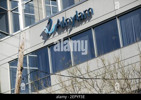 A logo sign outside of the headquarters of Alnylam Pharmaceuticals in ...