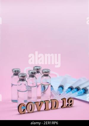 Prevention of seasonal diseases. Medical ampoules, syringes, and a mask ...