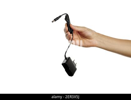 dc power adapter at caucasian persons hand. isolated on a white ...