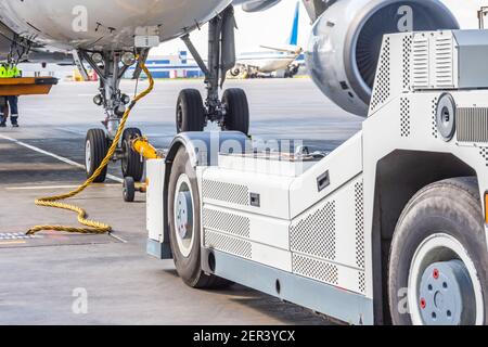 Commercial passenger airplane during push back operation. Shiny metal ...