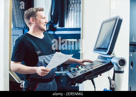 Machine operator programming modern industrial cnc lathe Stock Photo ...