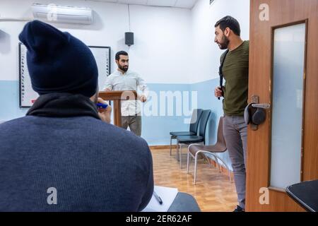 Arabic student coming late to class Stock Photo - Alamy