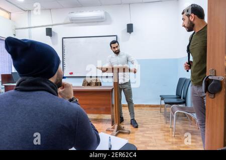 Arabic student coming late to class Stock Photo - Alamy