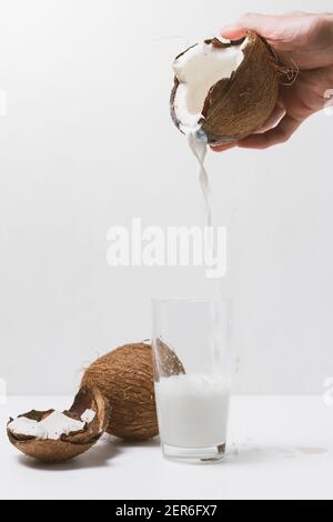 a man's hand pours milk from a bottle. artphotography Stock Photo - Alamy