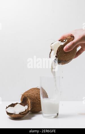 a man's hand pours milk from a bottle. artphotography Stock Photo - Alamy