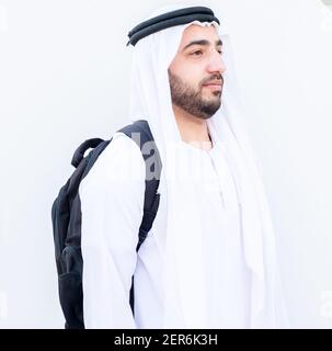 Arabic guy wearing his backpack and preparing to school Stock Photo - Alamy
