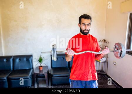 Guy doing some training at home to keep in good shape Stock Photo - Alamy
