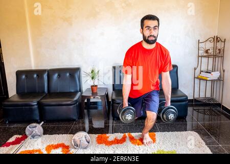 Guy doing some training at home to keep in good shape Stock Photo - Alamy