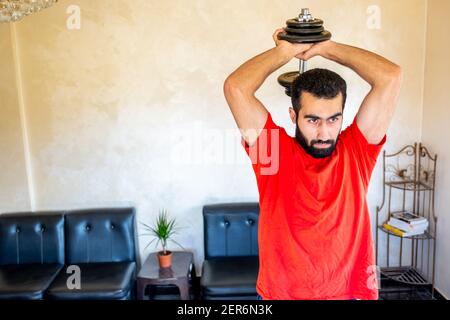 Guy doing some training at home to keep in good shape Stock Photo - Alamy