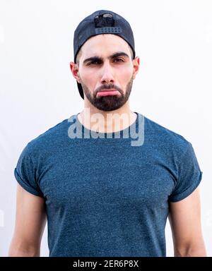 Guy making an expression of being angry and sad Stock Photo - Alamy