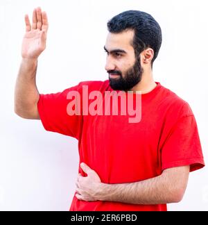Handsome man waving hand to say hello, giving high five, standing over ...
