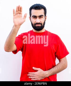 Guy standing and waving his to say hi Stock Photo - Alamy