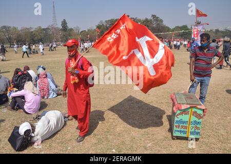A supporter holds a flag during the mega rally.The Communist party CPIM ...