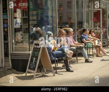 Bench seating at a coffee shop restaurant with small cafe tables and ...