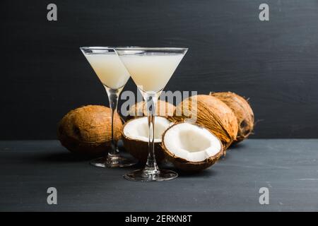 Sweet coconut cocktail in martini glass on the wooden background ...