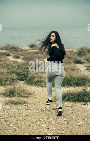 Scared young woman running away in the dark looking over shoulder Stock ...