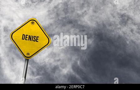 Denise - yellow sign with blue sky background Stock Photo - Alamy