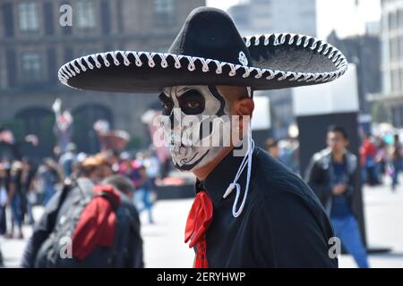 A Man dressed as Charro and the face painted as a skull looks during ...