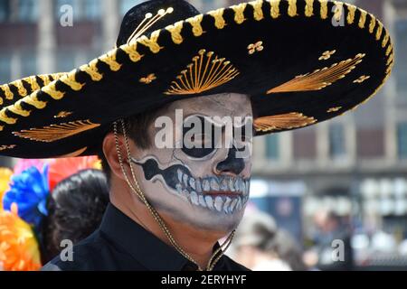 A Man dressed as Charro and the face painted as a skull looks during ...