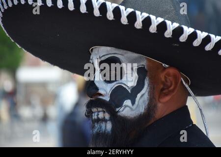 A Man dressed as Charro and the face painted as a skull looks during ...