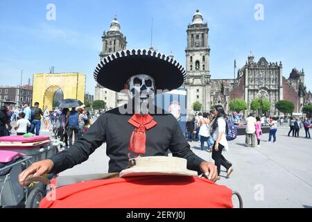 A Man dressed as Charro and the face painted as a skull looks during ...