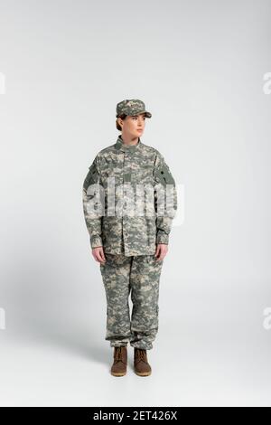 A professional soldier in full military gear striding through the dark ...