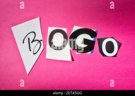 The acronym BOGO" Buy One Get One )using cut-out paper letters in the ...
