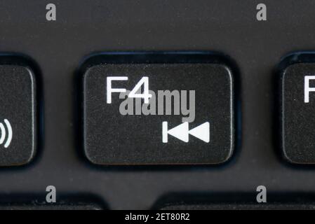 F4 and play previous track key on a laptop keyboard Stock Photo - Alamy