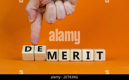 Demerit or merit symbol. Businessman turns wooden cubes and changes the ...