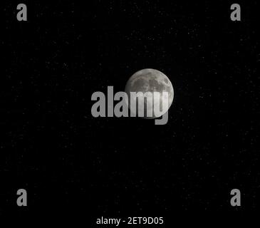 A mesmerizing view of a moon in the dark sky at night seen through the ...