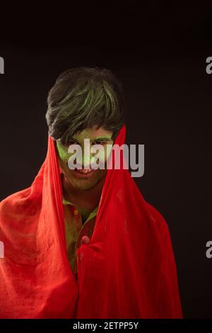 Young Indian man posing, playfully framing his face with his hands in ...