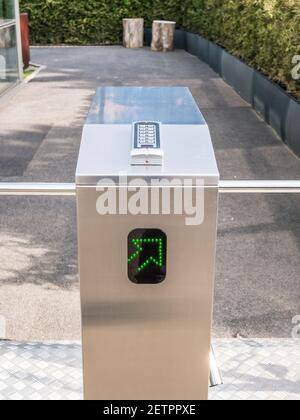 Modern automated metallic turnstile entrance system with stop sign on ...