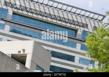 A logo sign outside of the headquarters of Cash America International ...