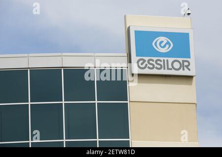 A logo sign outside of the headquarters of Essilor of America in Dallas ...