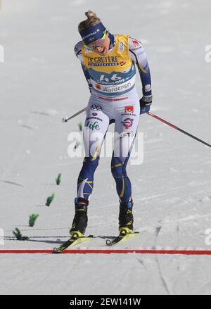 Frida Karlsson, of Sweden, crosses the finish line to win the gold ...