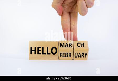 Symbol for the change from February to March. Businessman turns wooden ...