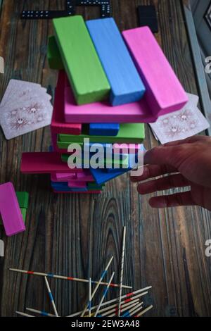 A top view of colorful Jenga game blocks stacked on each other, playing ...