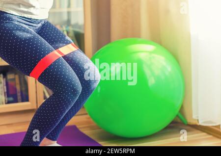 Woman during home workout with a rubber resistance bands Stock Photo ...