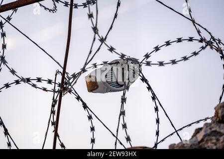 shoe stuck in barbed wire in urban environment Stock Photo - Alamy