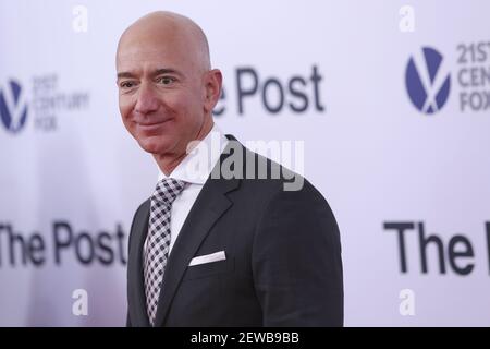 Jeff bezos poses as he arrives on the red carpet for 'The Post' premier ...